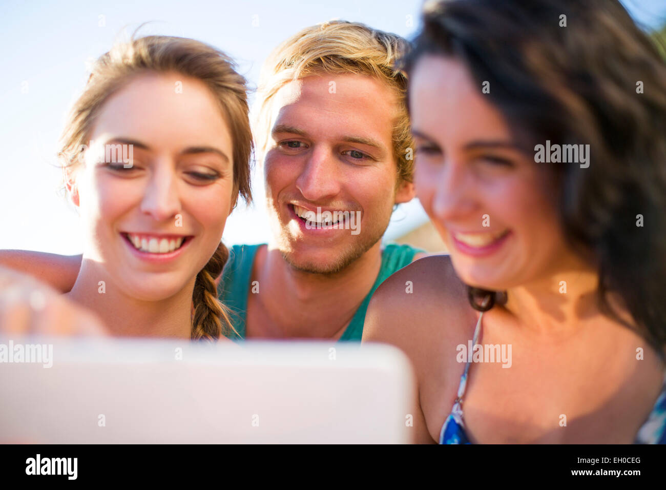 Friends interacting with a tablet outdoors Stock Photo - Alamy