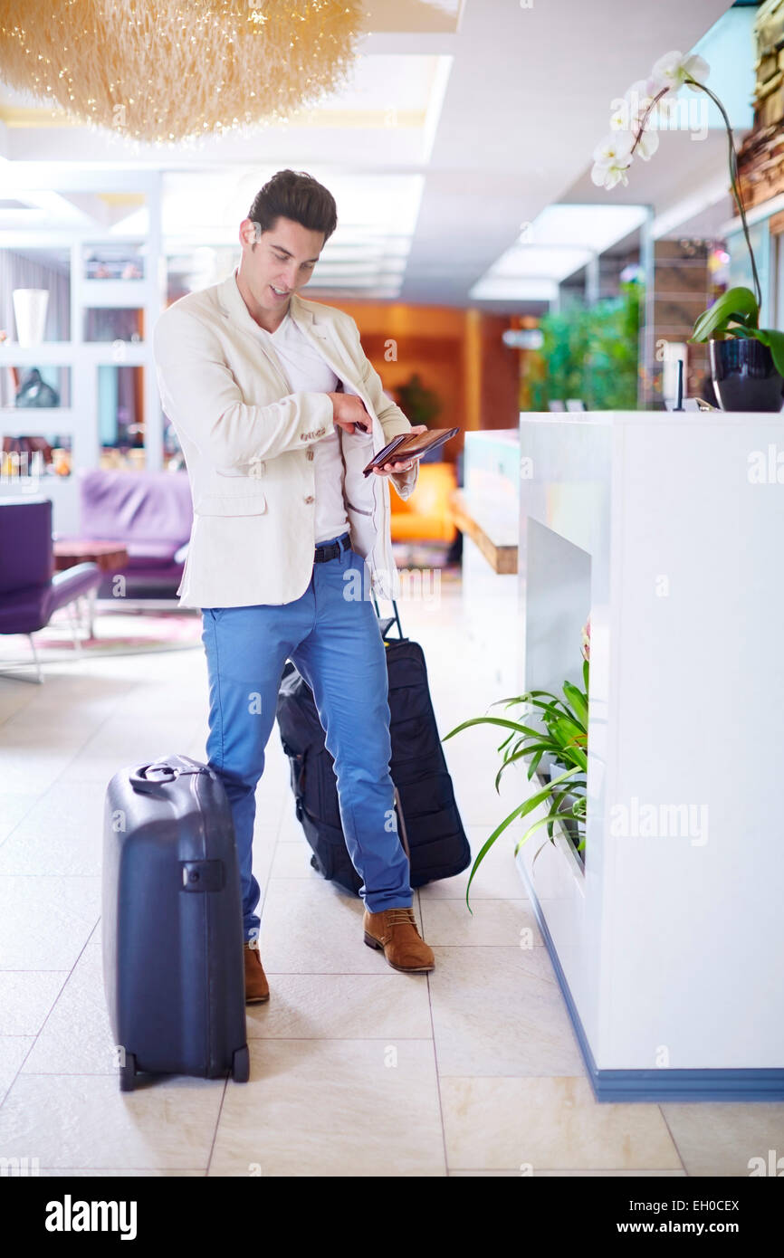 Businessman arriving at hotel reception Stock Photo - Alamy