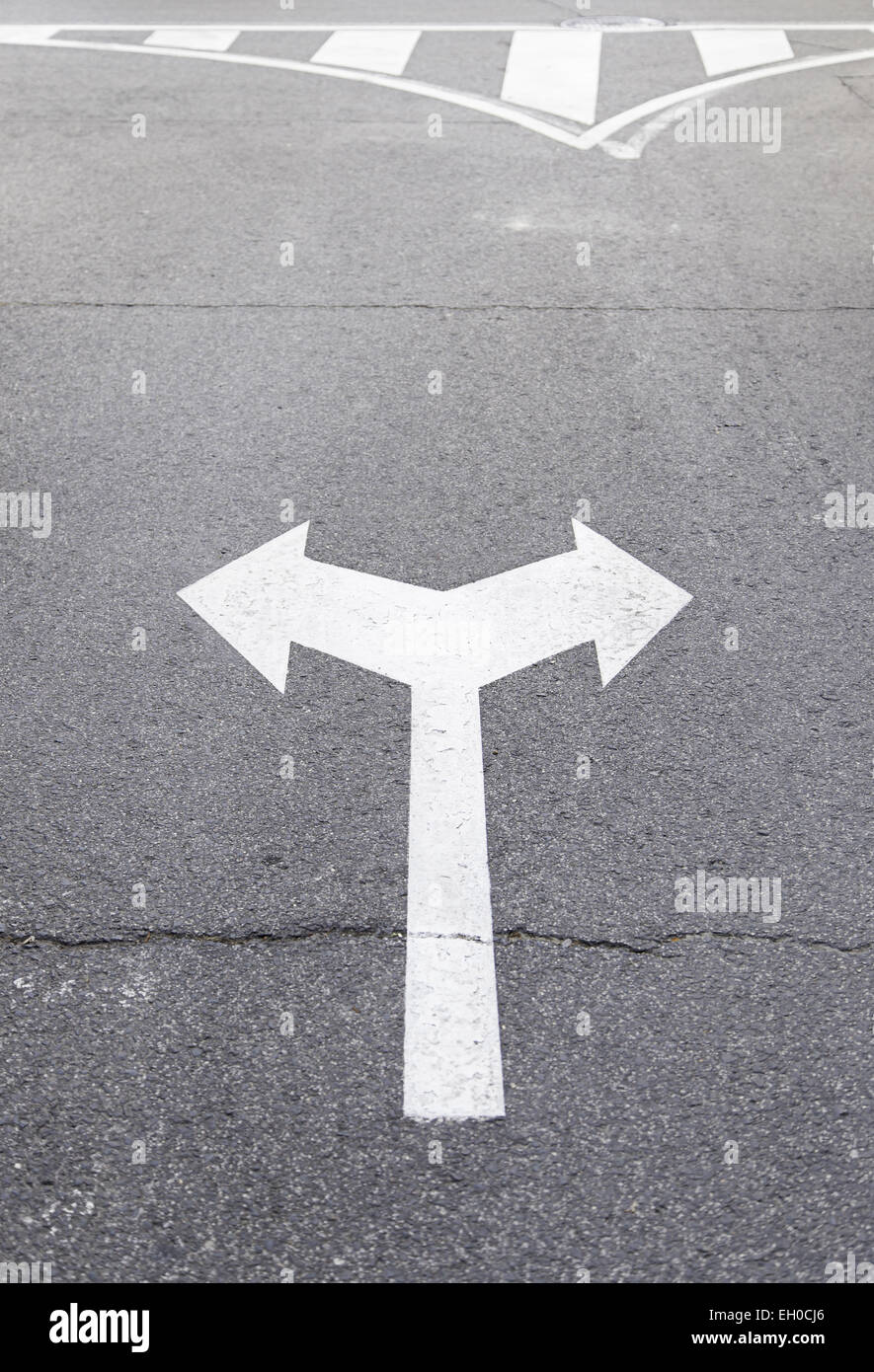 Arrow direction on asphalt, detail of a direction sign, road safety ...