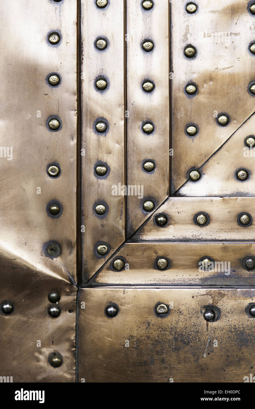 Background copper rivets, detail of a wall decorated with copper, shiny ...
