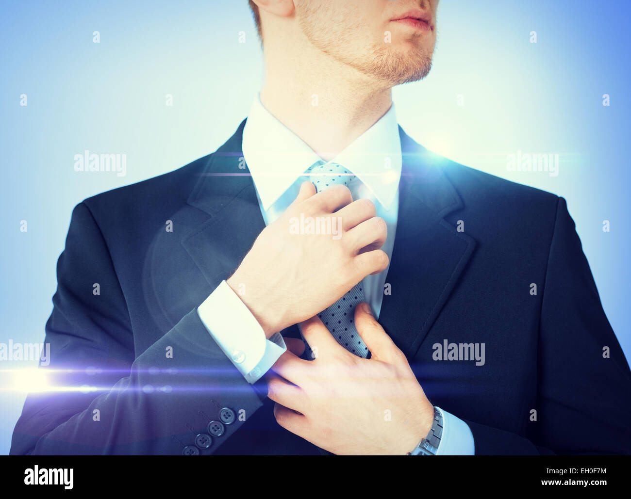 man adjusting his tie Stock Photo - Alamy