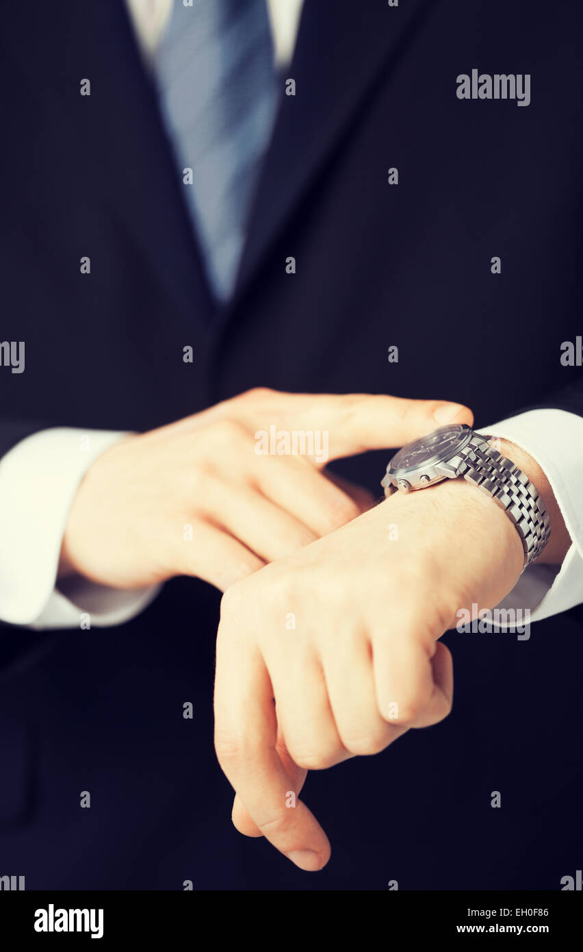 man looking at wristwatch Stock Photo - Alamy
