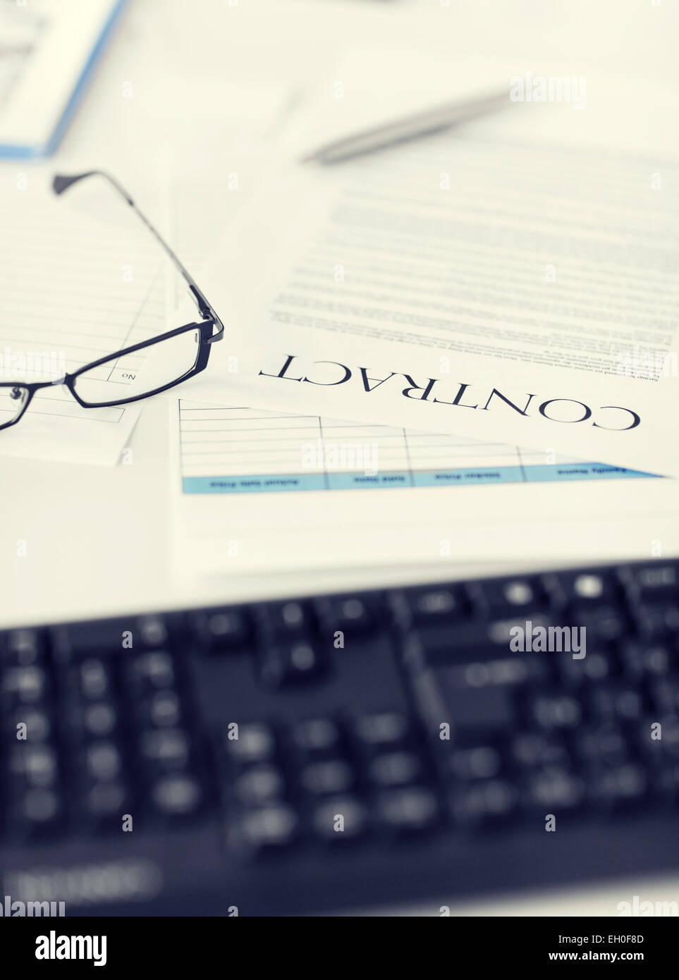 signed contract paper with glasses Stock Photo - Alamy