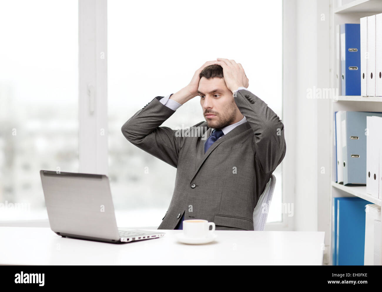 busy businessman with laptop and coffee Stock Photo - Alamy