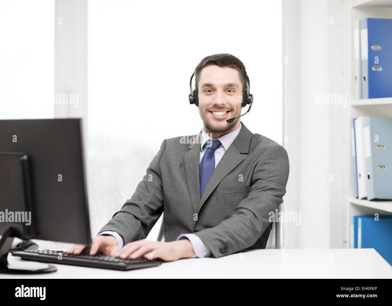helpline operator with headphones and computer Stock Photo - Alamy