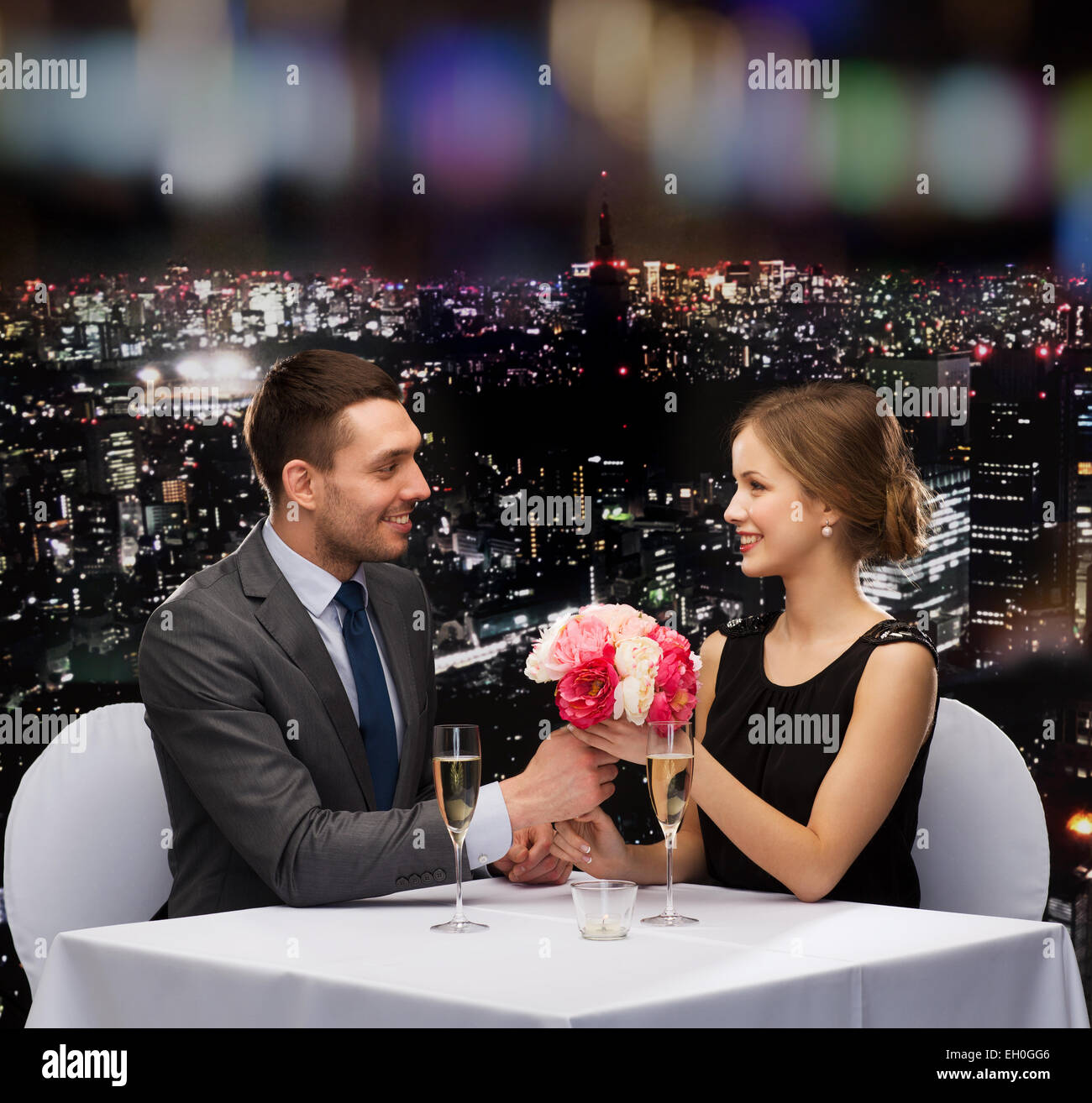 smiling man giving flower bouquet to woman Stock Photo - Alamy