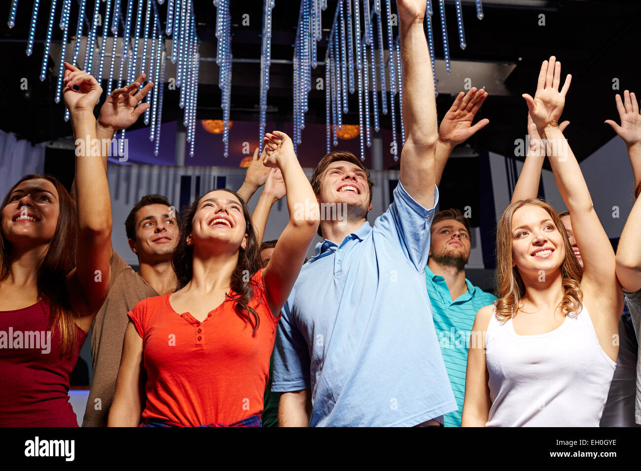 group of smiling friends at concert in club Stock Photo - Alamy