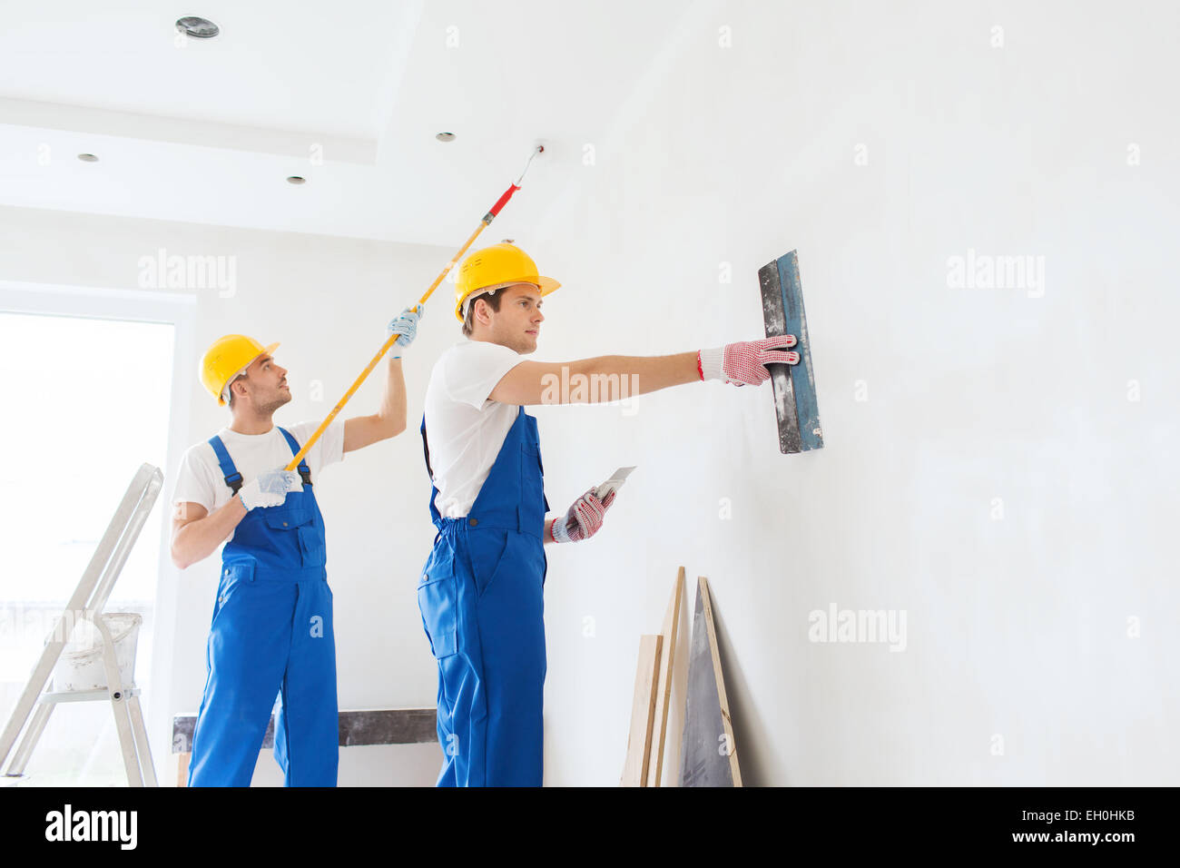 group of builders with tools indoors Stock Photo - Alamy