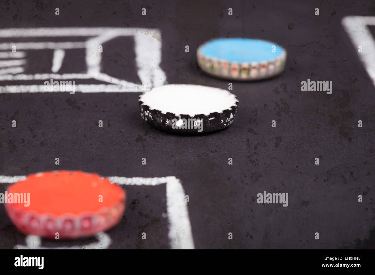 Skully bottle caps filled with melted crayons for the game of Skully ...