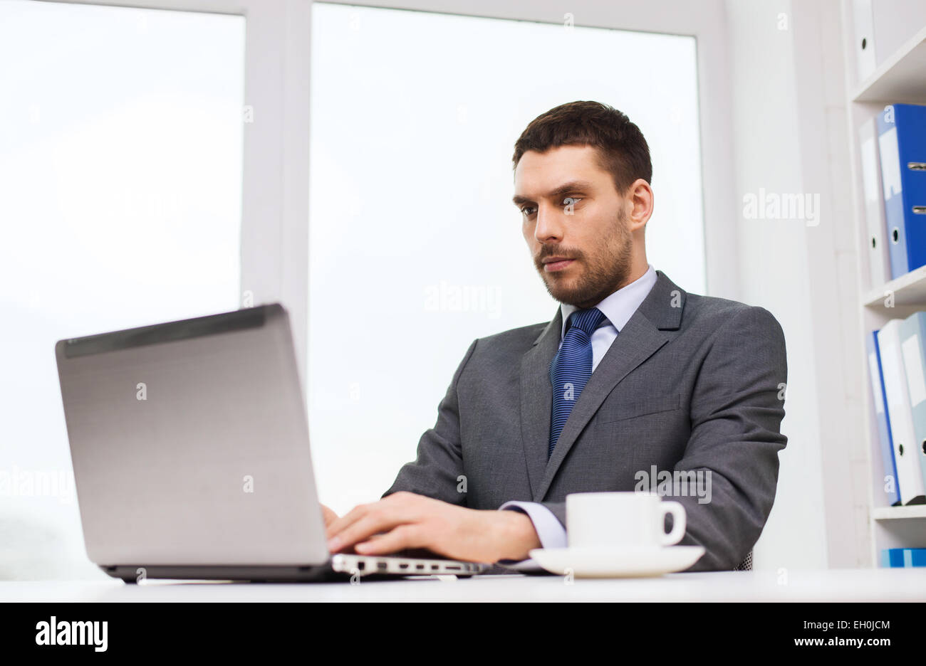 businessman with laptop typing in office Stock Photo - Alamy