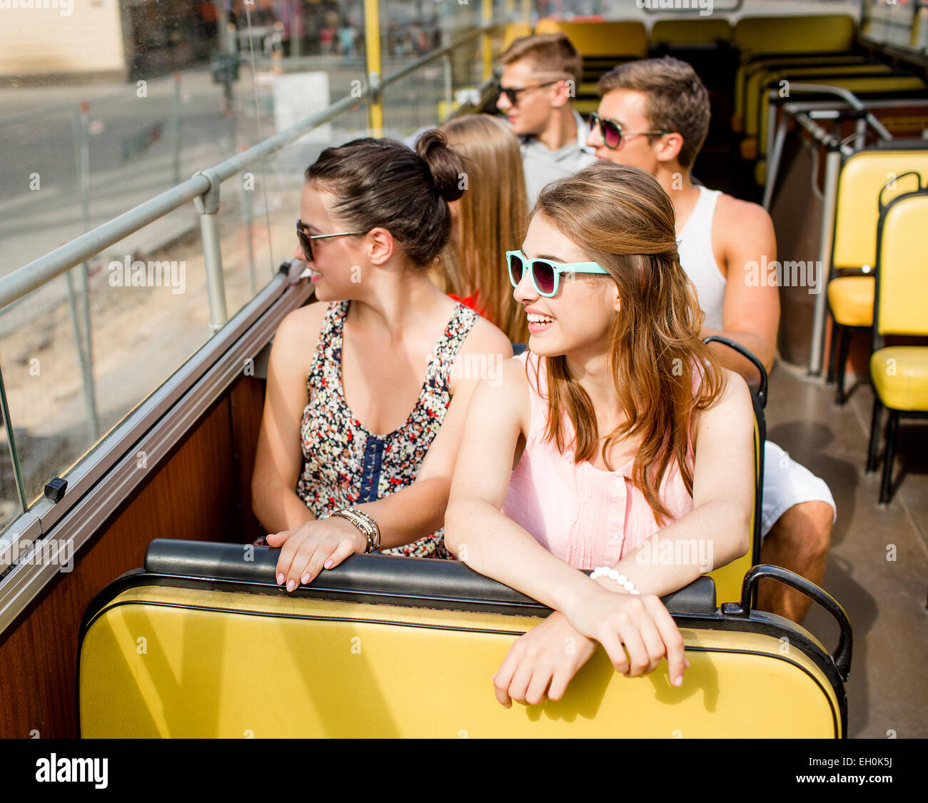 group of smiling friends traveling by tour bus Stock Photo - Alamy