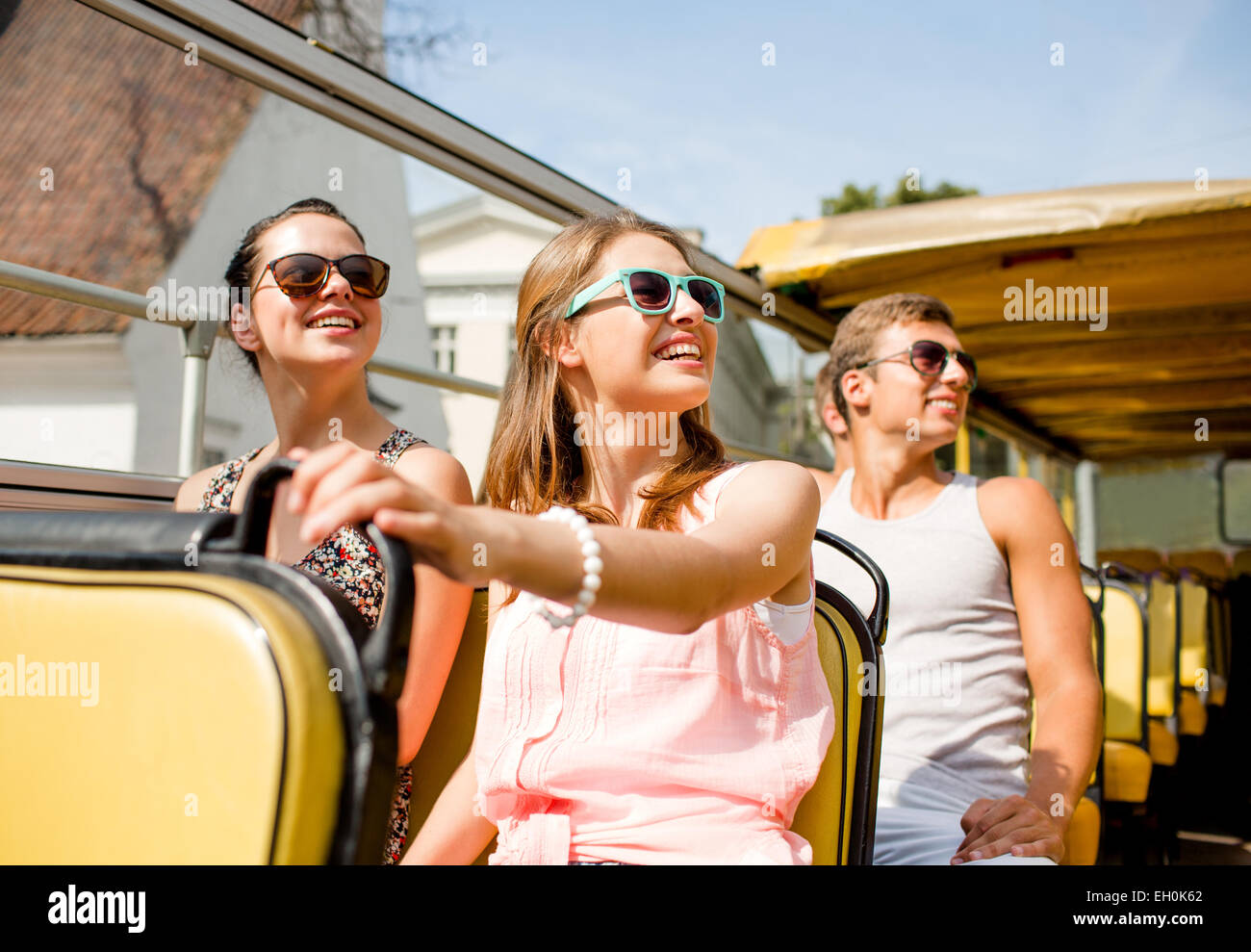 group of smiling friends traveling by tour bus Stock Photo - Alamy