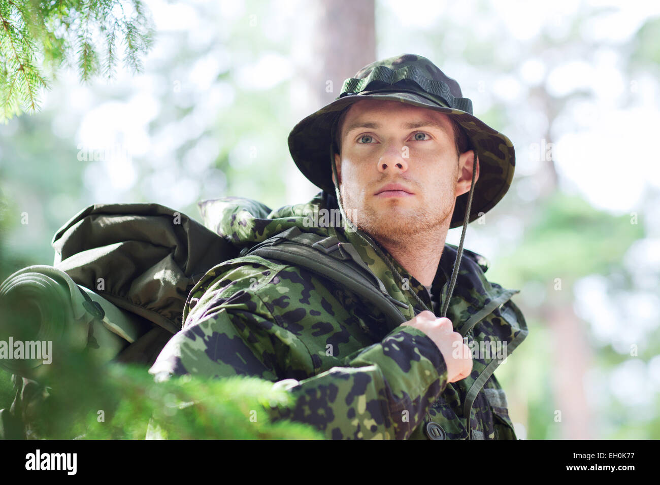young soldier with backpack in forest Stock Photo - Alamy