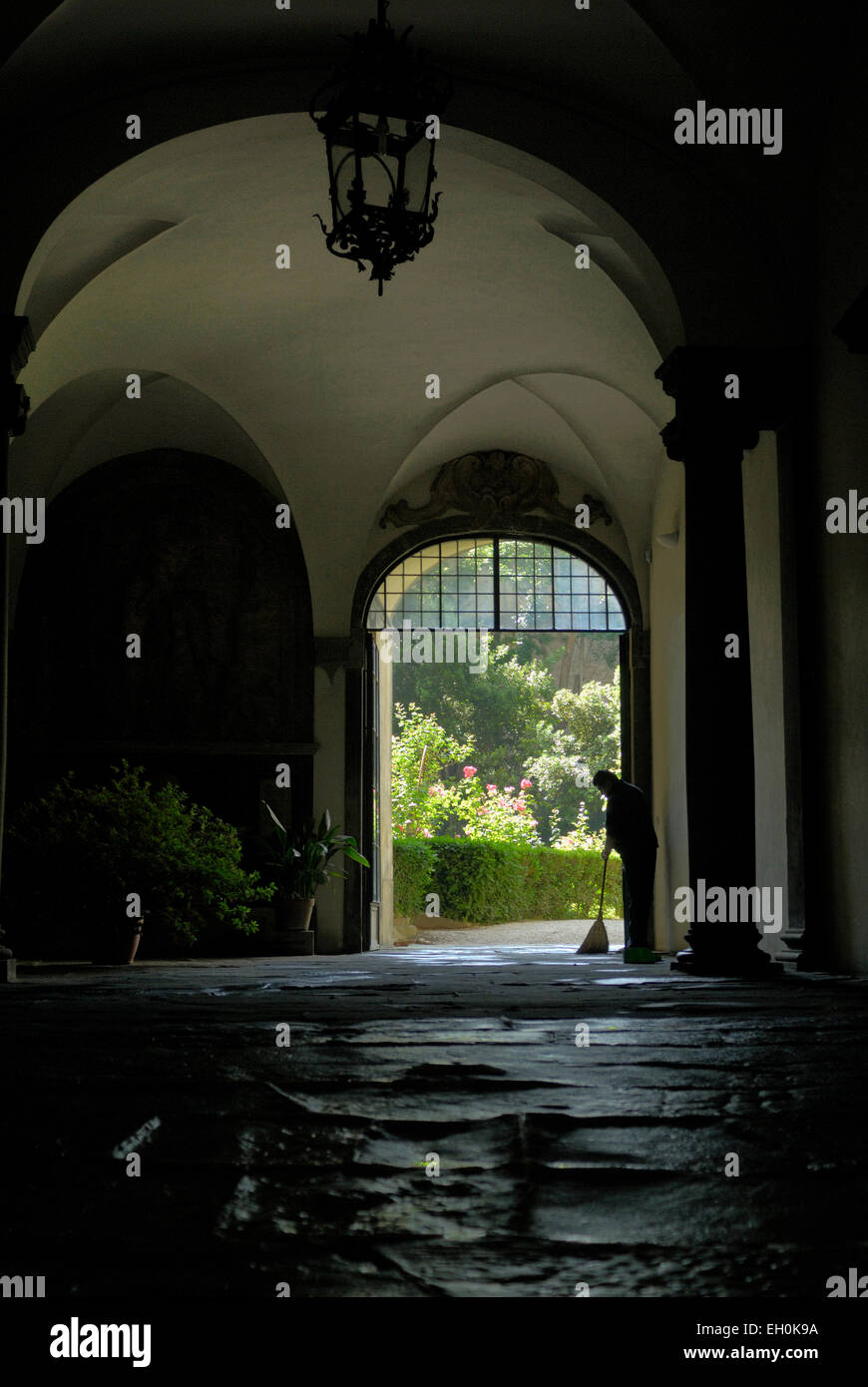 A garderner sweeping a stone floor with a broom, Florence, Italy Stock ...