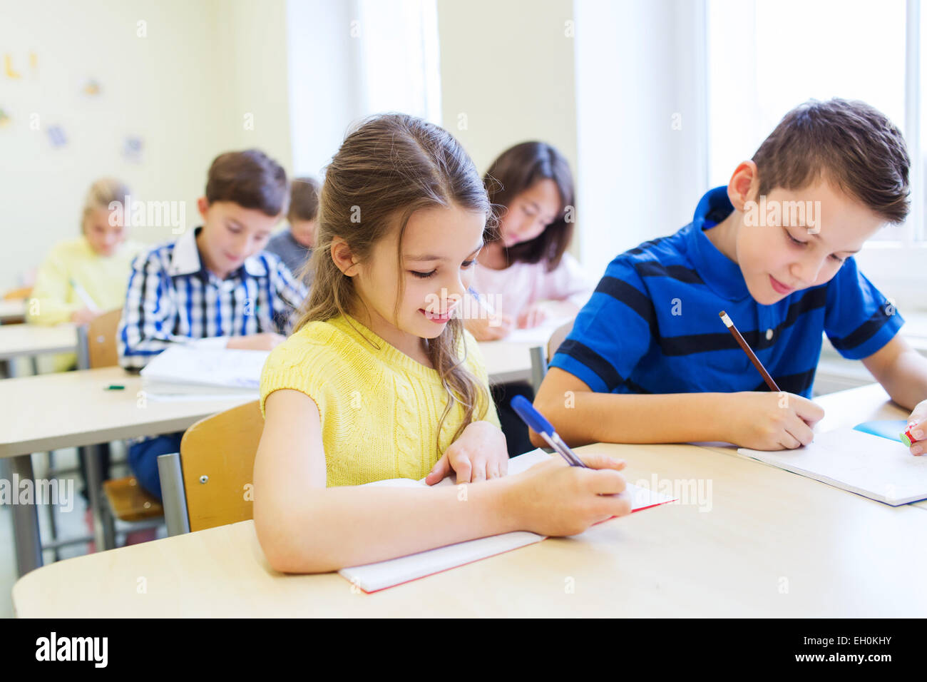 group of school kids writing test in classroom Stock Photo - Alamy