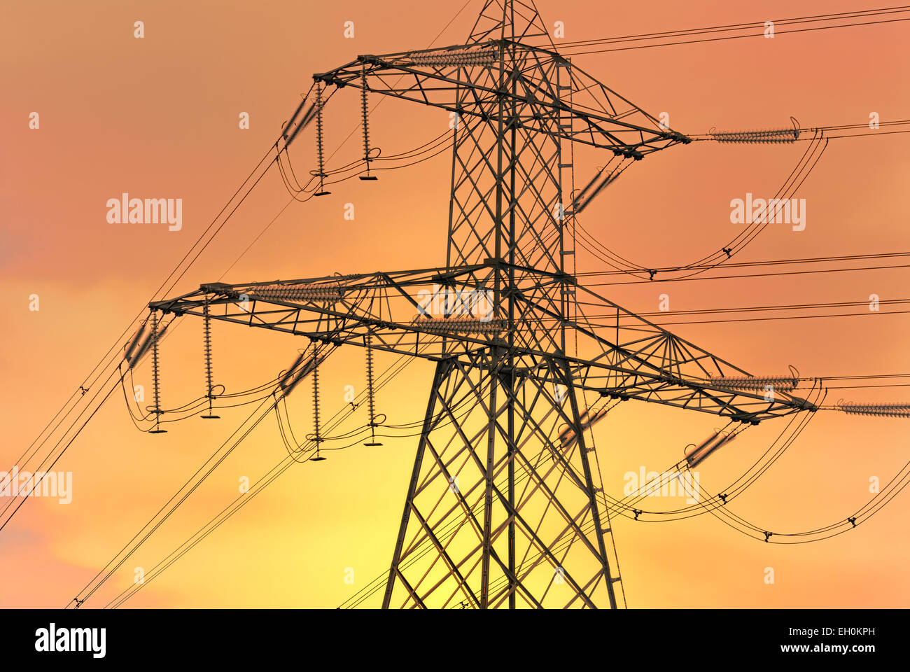 High voltage power supply lines attched to steel pylon Stock Photo - Alamy