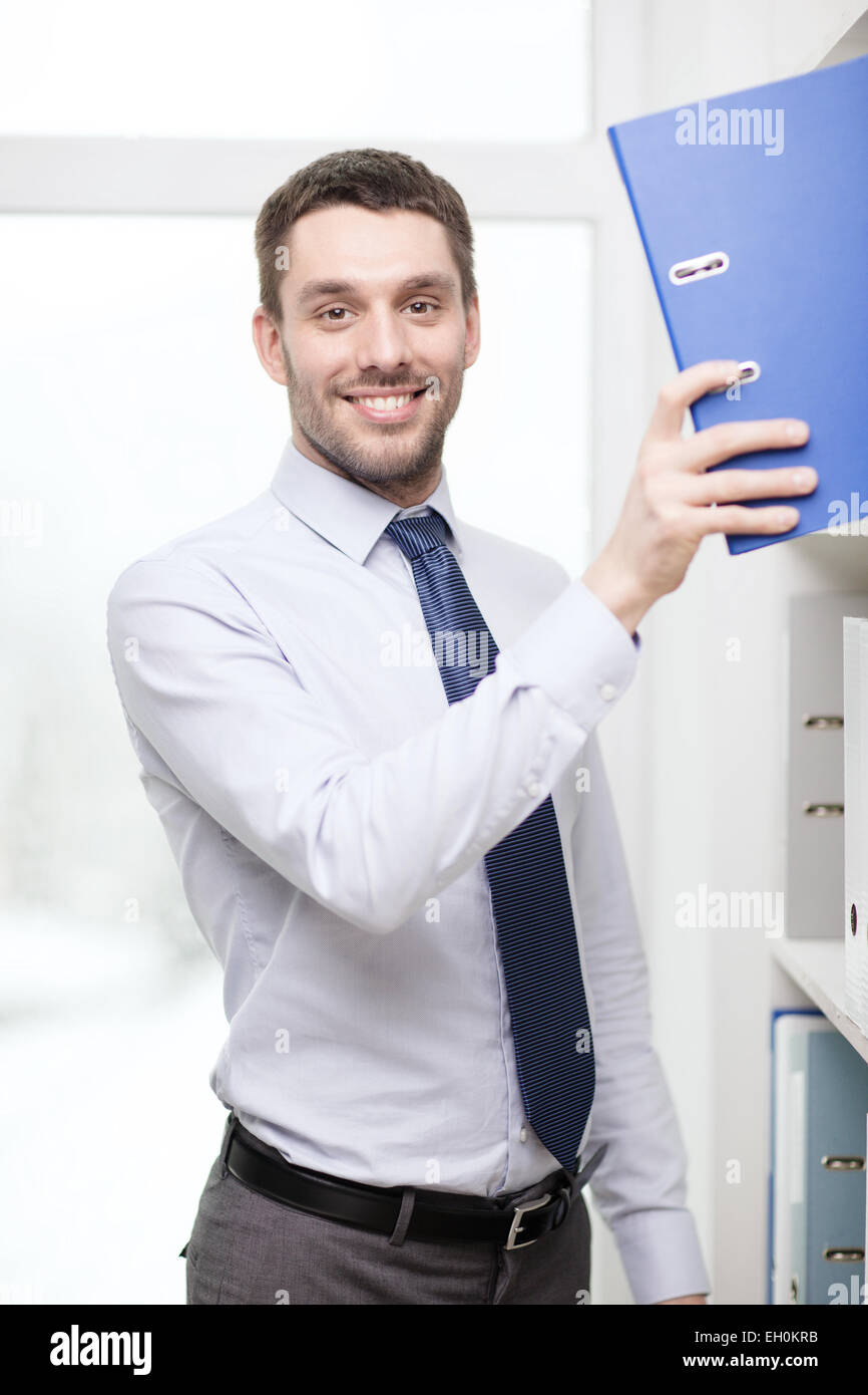 handsome businessman picking folder at office Stock Photo - Alamy
