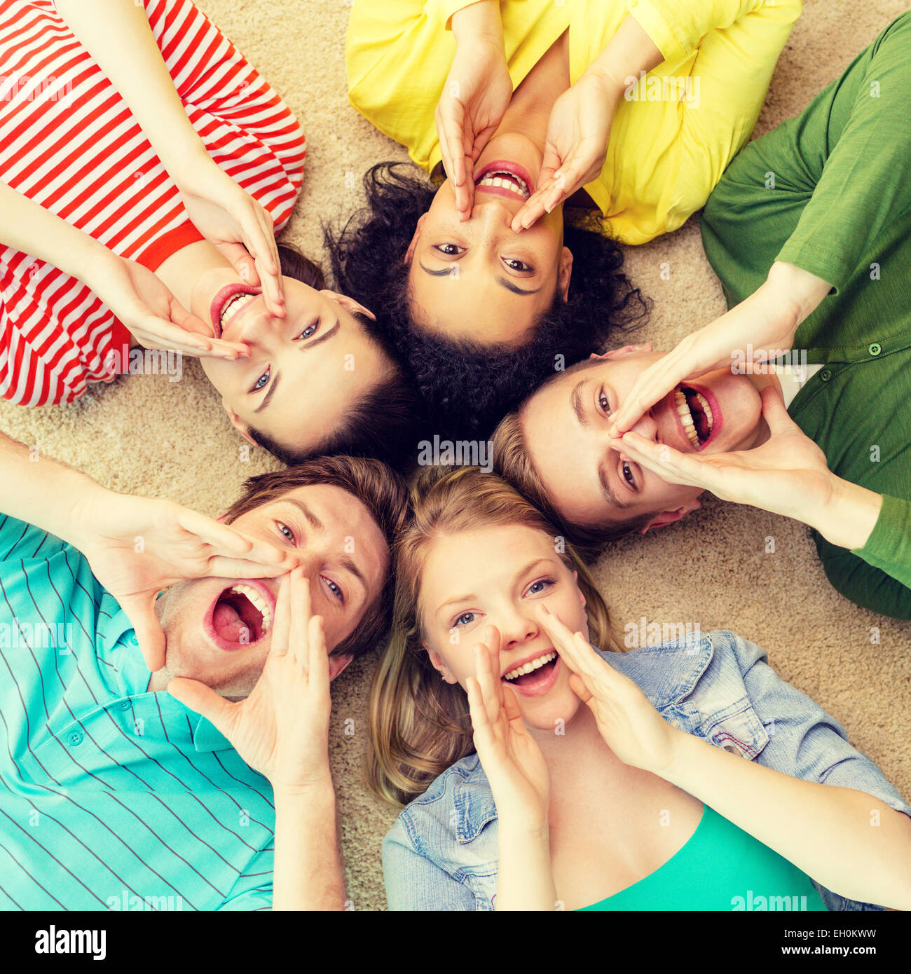 smiling people lying down on floor and screaming Stock Photo - Alamy