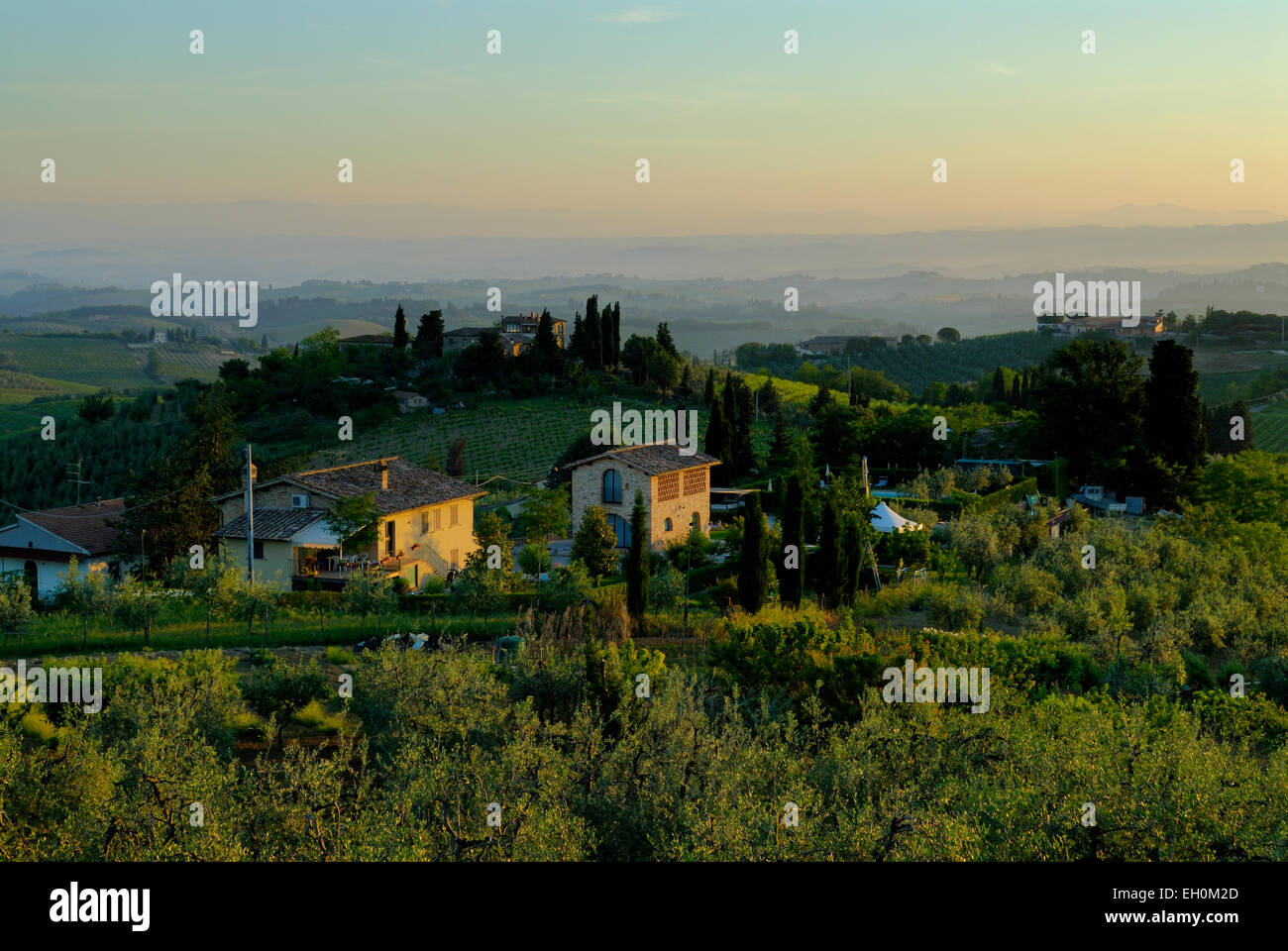 Tuscan landscape with farm houses surrounding the town of San Gimignano ...