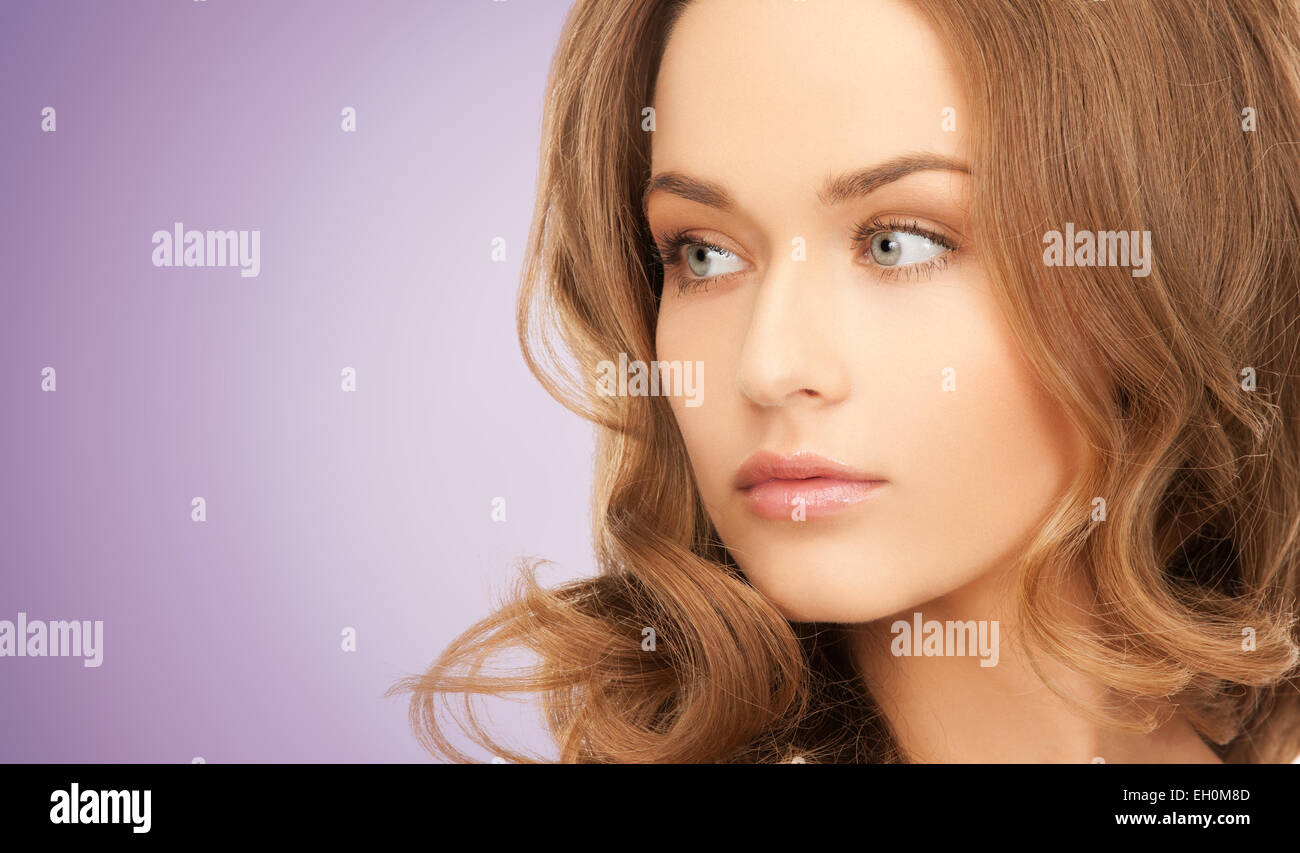 beautiful young woman face over violet background Stock Photo - Alamy
