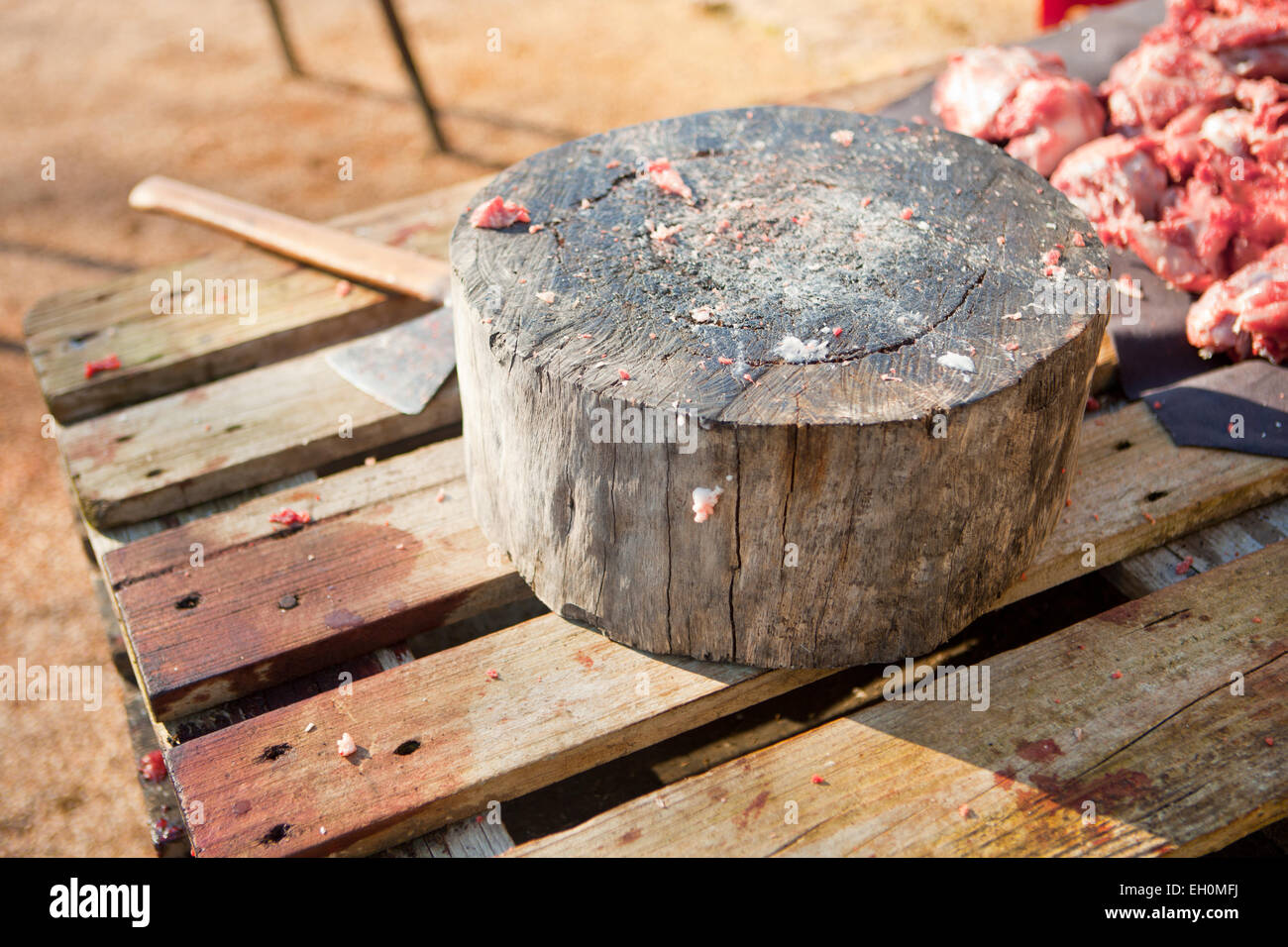 Stump tree for cutting the meat. Traditional home slaughtering in a ...