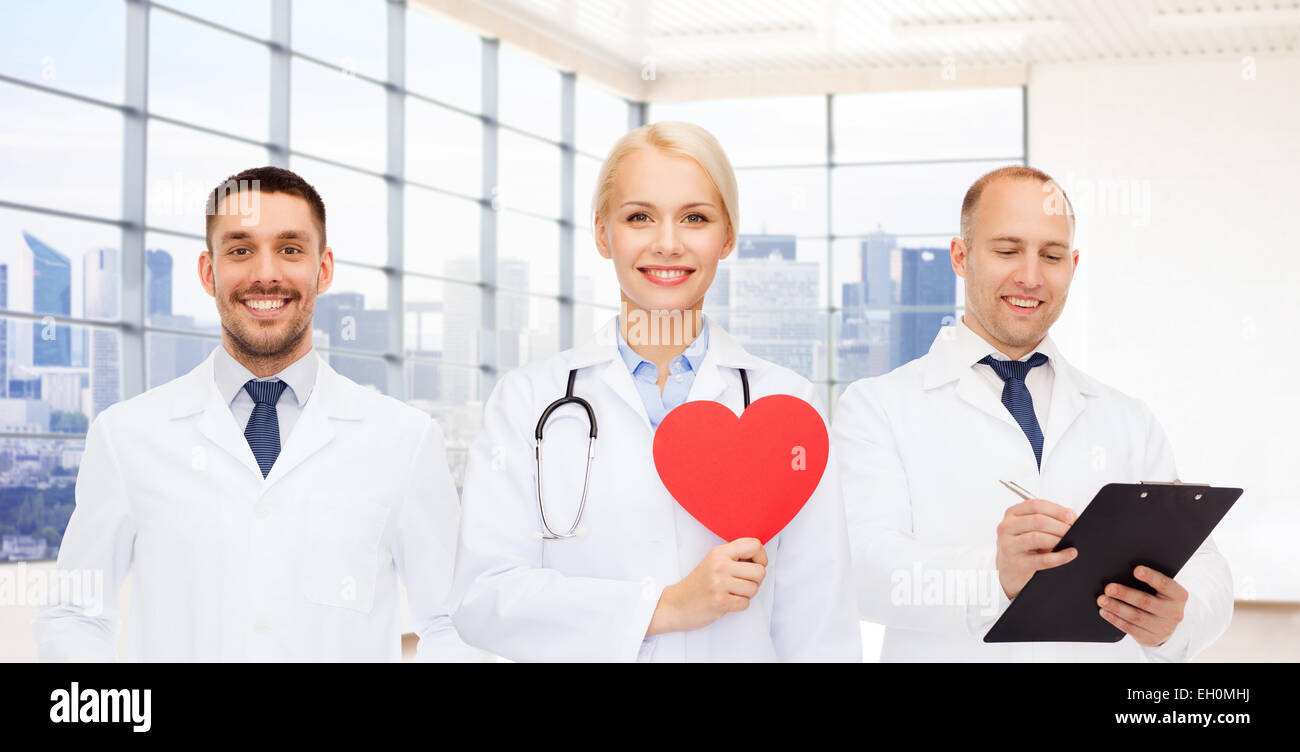 happy young doctors cardiologists with red heart Stock Photo - Alamy