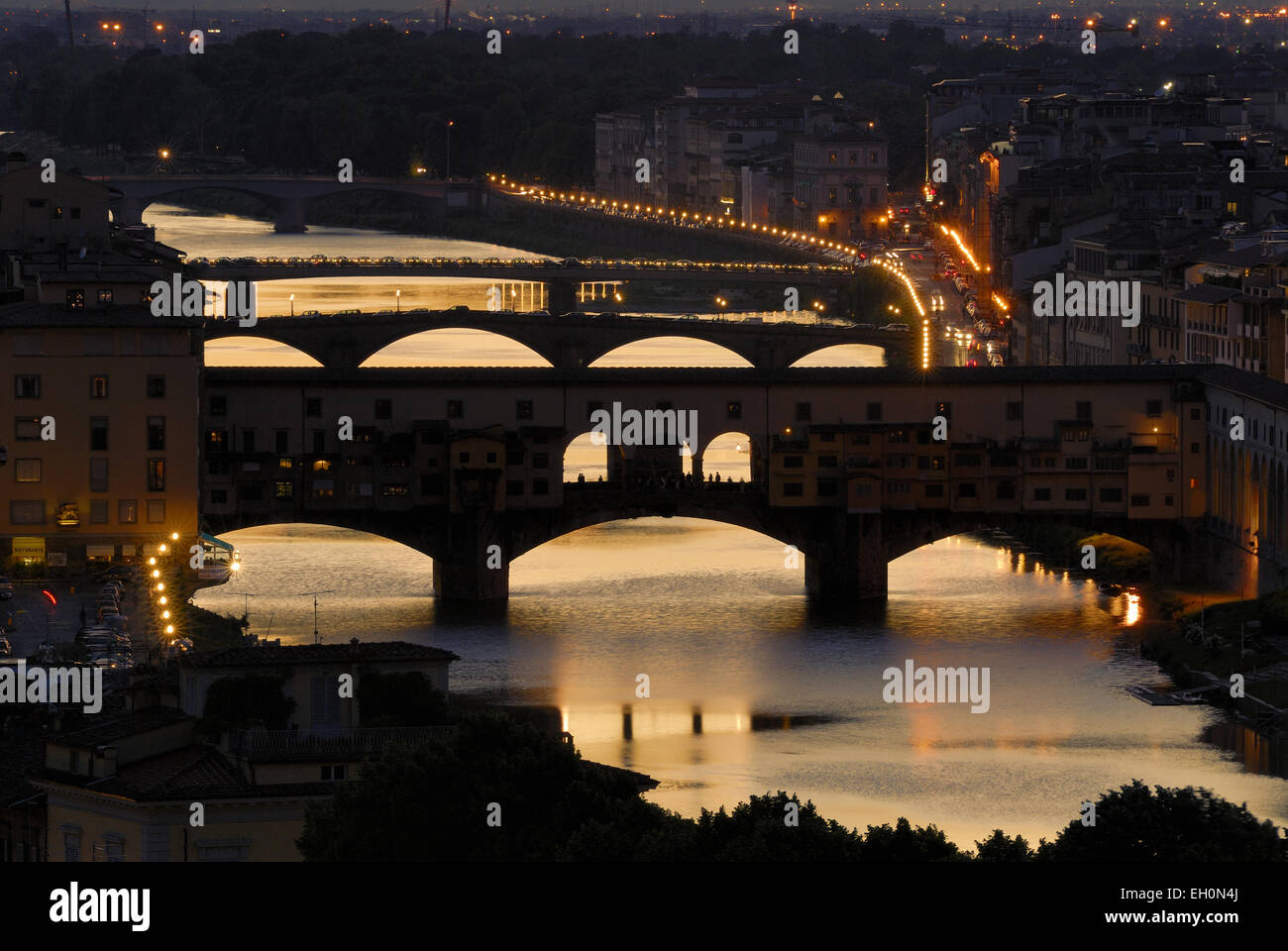 Florence skyline with Arno river and Ponte Vecchio bridge at twilight ...