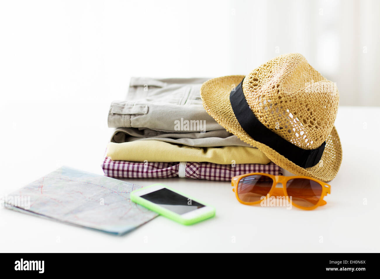 close up of summer clothes and travel map on table Stock Photo - Alamy