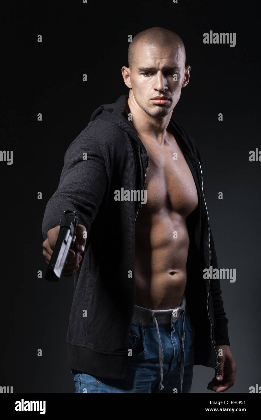 man shooting gun isolated on black background Stock Photo - Alamy