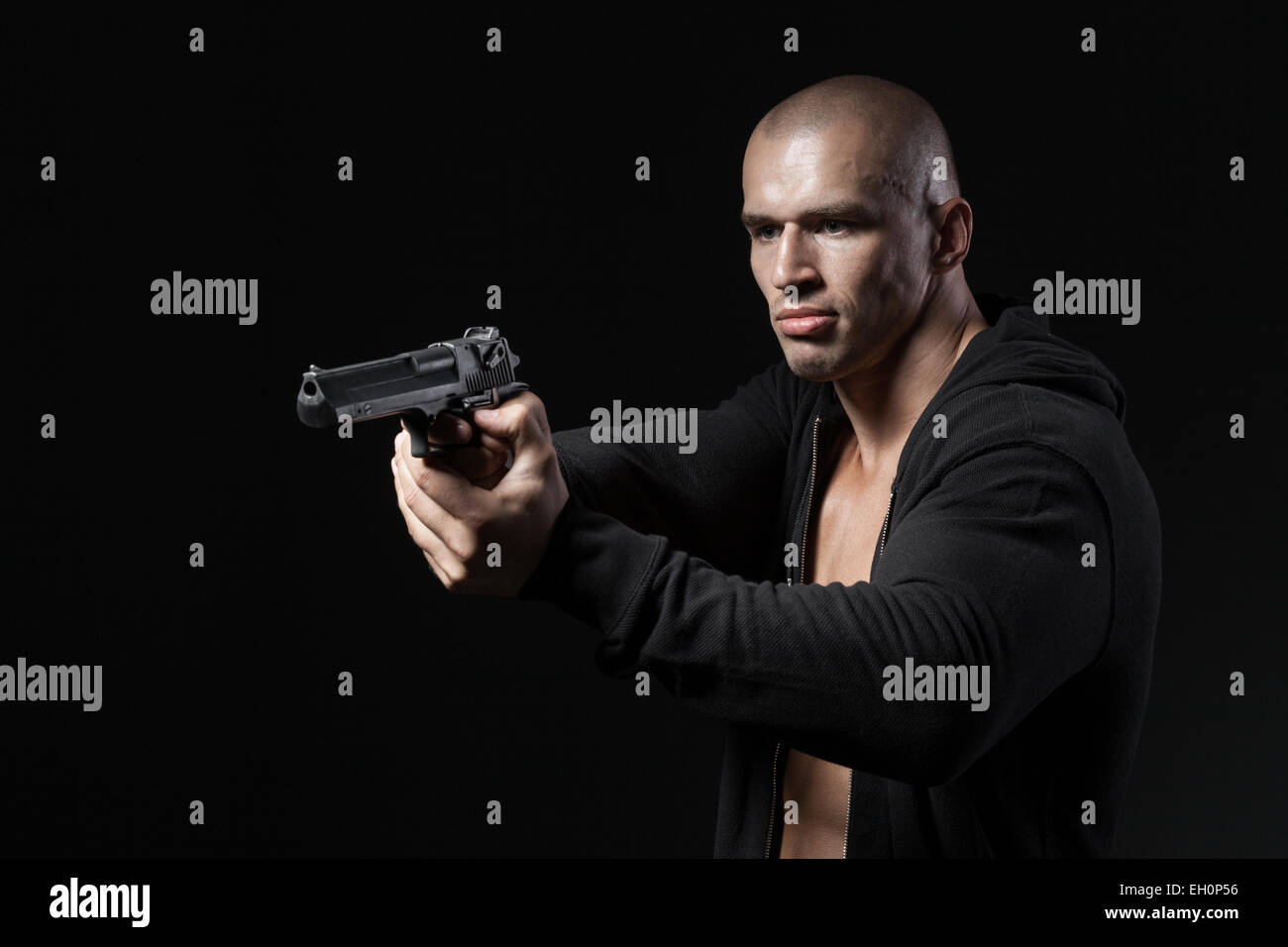 man shooting gun isolated on black background Stock Photo - Alamy