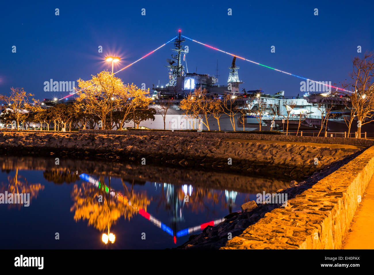 USS Midway Museum ship illuminated in the early morning at Tuna Harbor ...