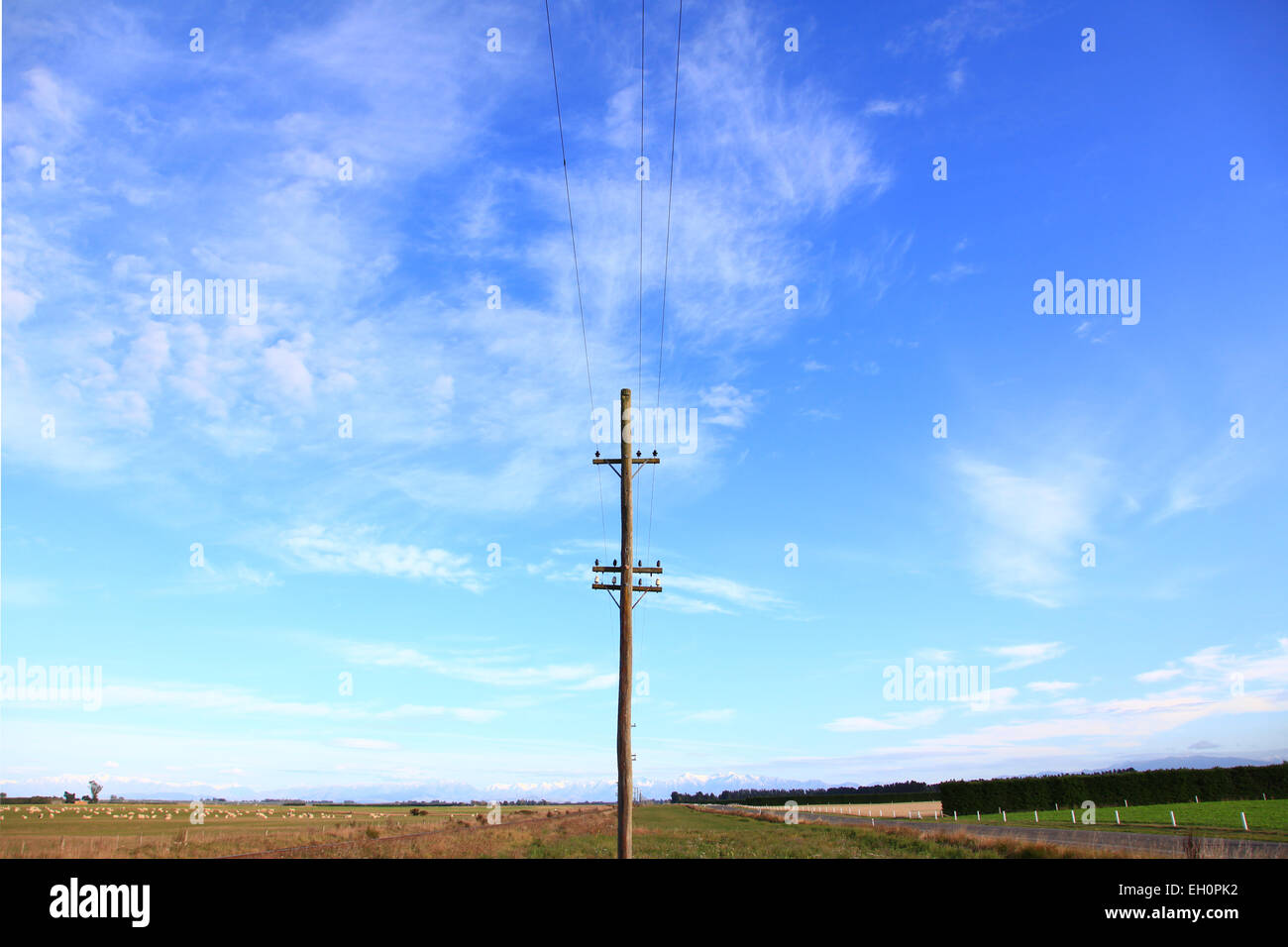 electric power post with sunny sky Stock Photo - Alamy