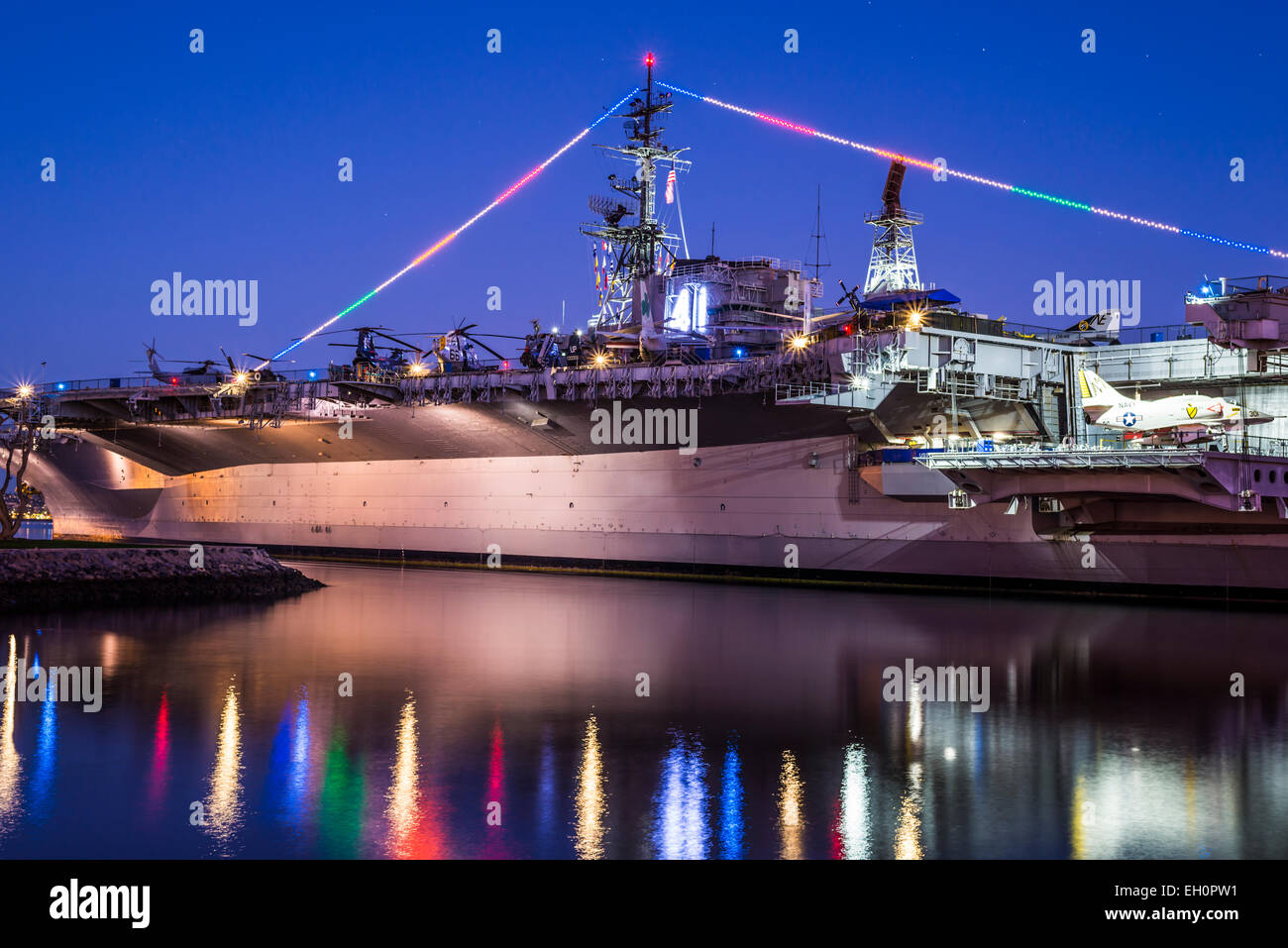 USS Midway Museum ship illuminated in the early morning at Tuna Harbor ...