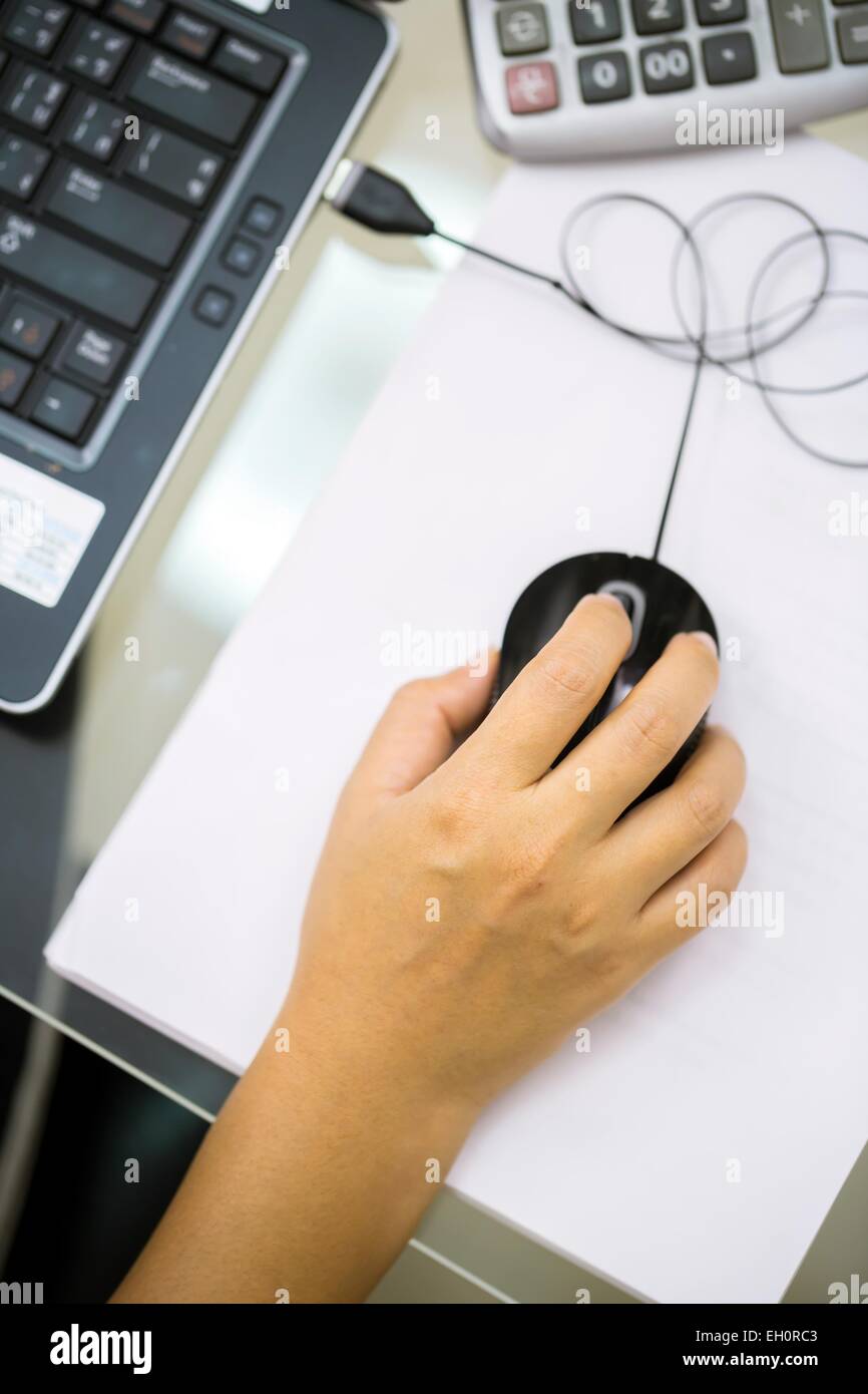 Businesswoman working with laptop and mouse Stock Photo - Alamy