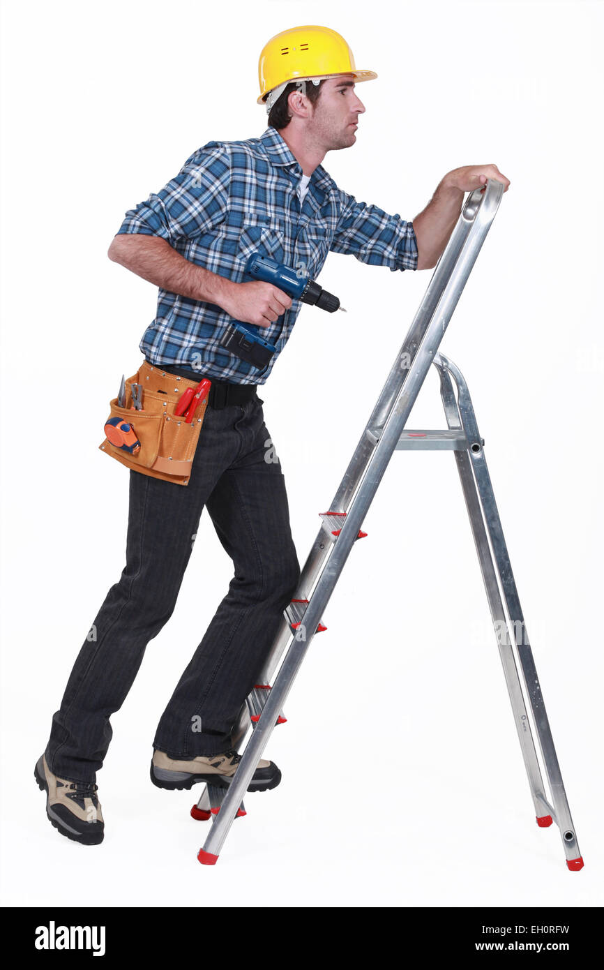 A handyman climbing a ladder Stock Photo - Alamy
