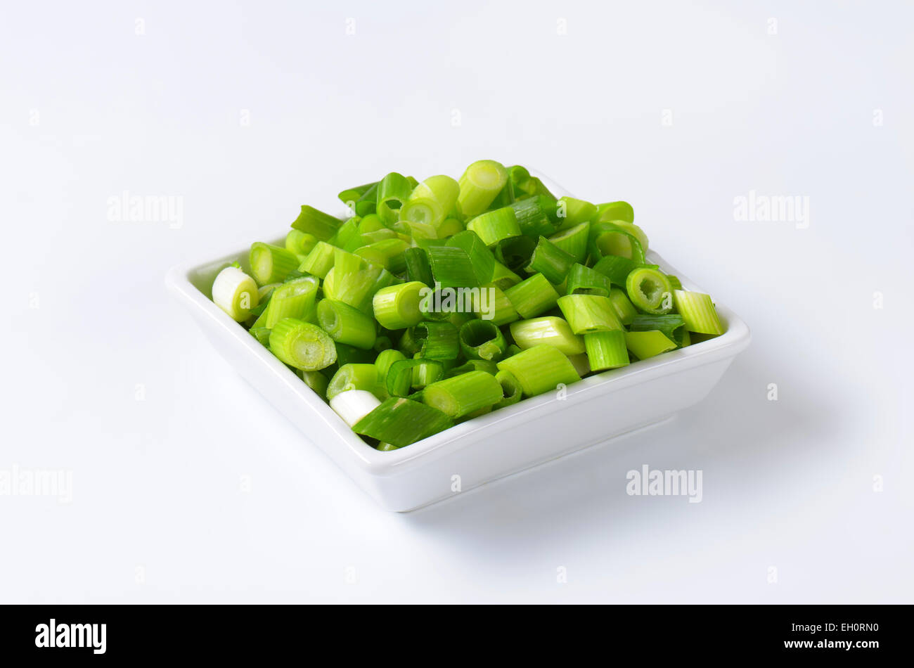 Chopped spring onions in square bowl Stock Photo - Alamy