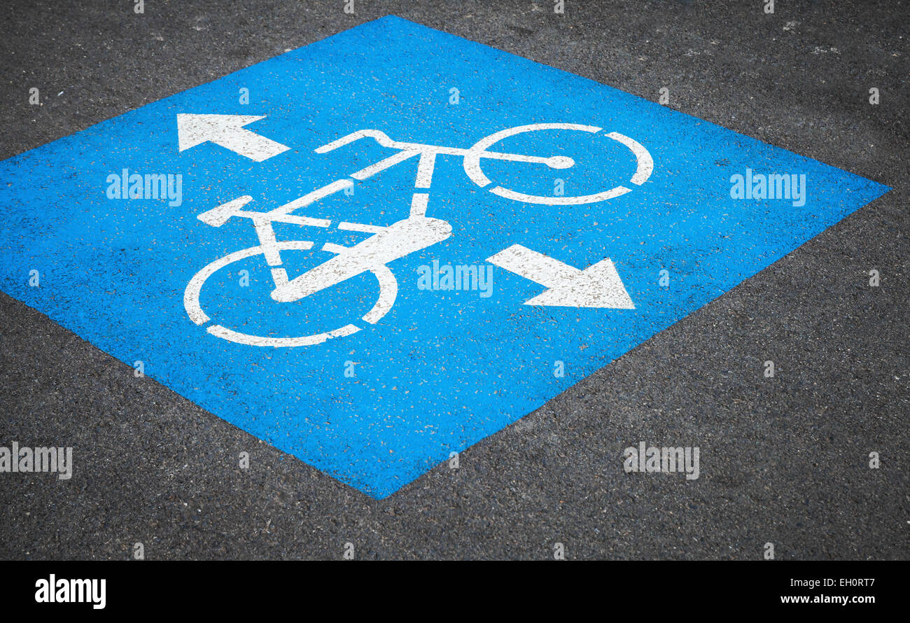 Bicycle lane. Closeup photo of blue and white road marking over urban ...