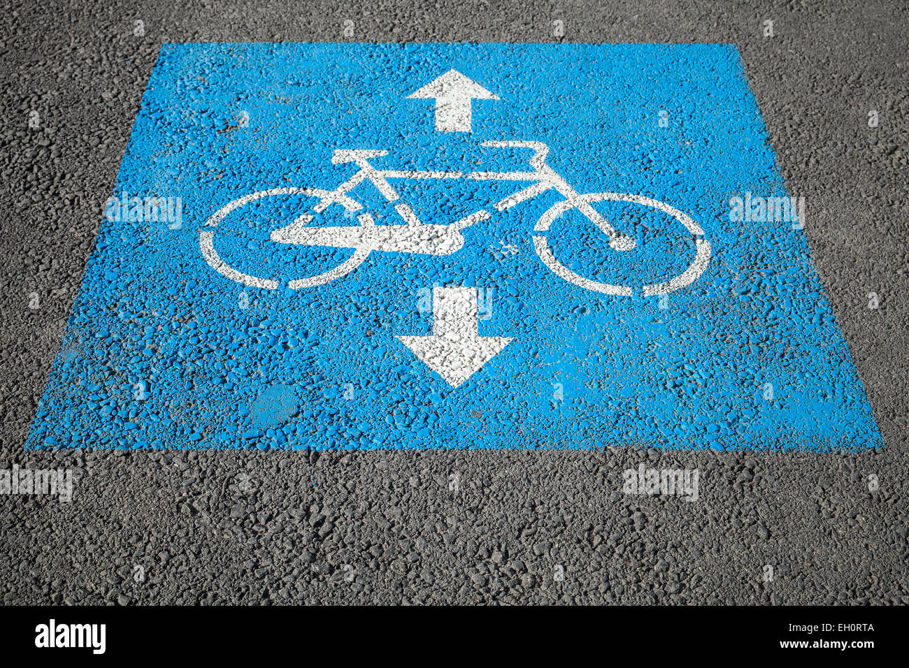 Bicycle lane. Blue and white road marking over urban asphalt road Stock ...