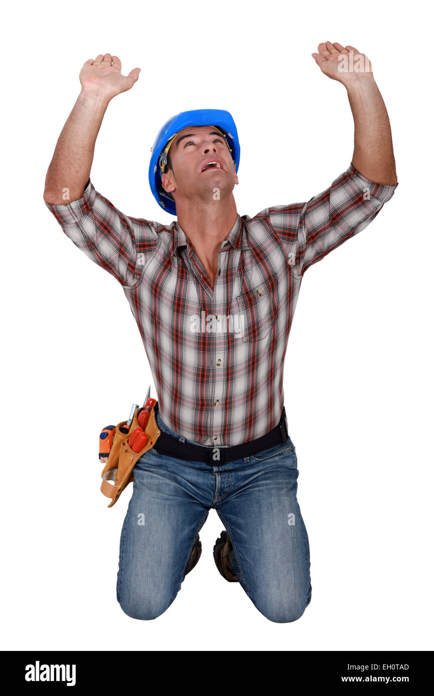 Builder holding up invisible object Stock Photo - Alamy