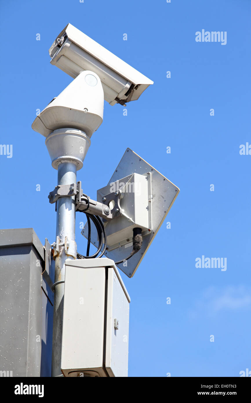 isolated Surveillance Security Camera or CCTV on blue sky, left ...