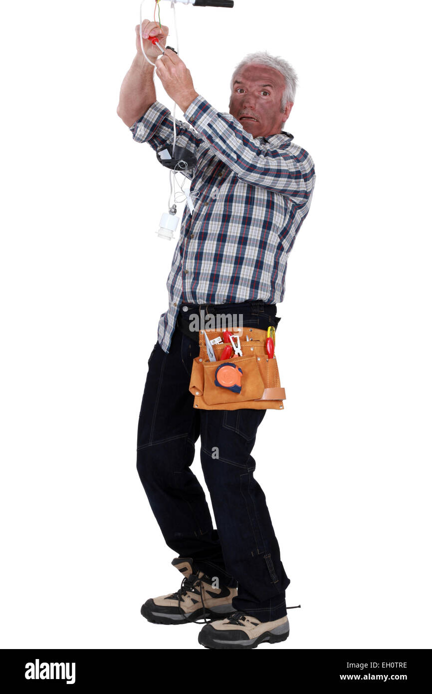 Electrocuted man wiring a light fitting Stock Photo - Alamy