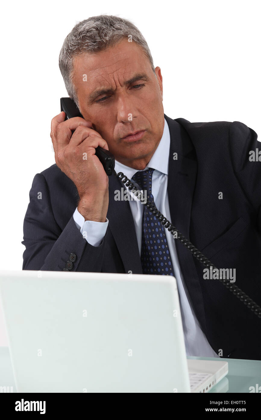 Mature businessman taking important call Stock Photo - Alamy