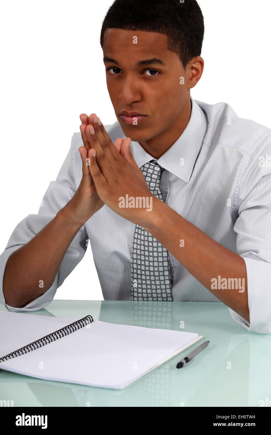 Uninspired young man sitting in front of an empty notebook Stock Photo ...