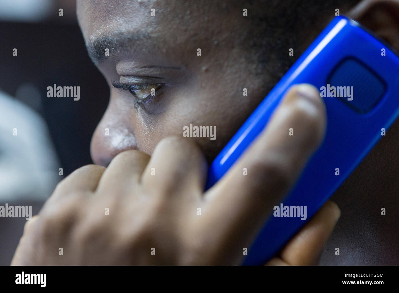 Lagos, Nigeria; A young woman on her mobile phone in a city office ...