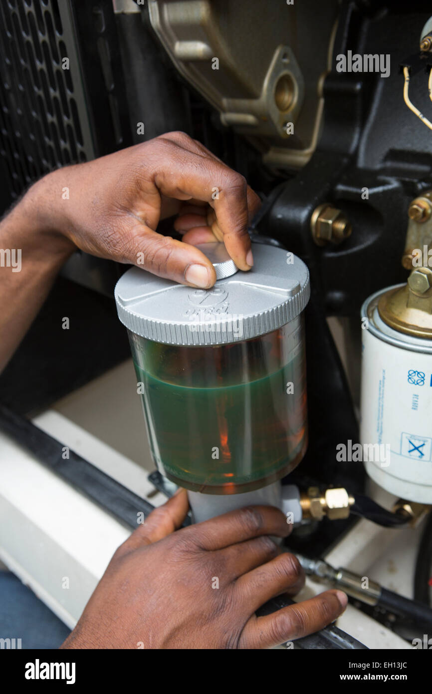 Lagos, Nigeria; changing an oil filter on a diesel electricity ...