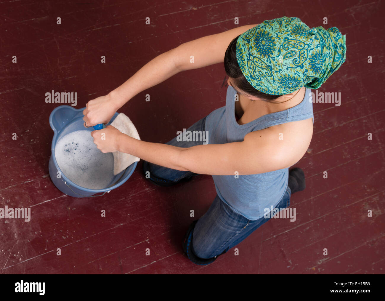 A woman tries to finish cleaning the floor by hand Stock Photo - Alamy