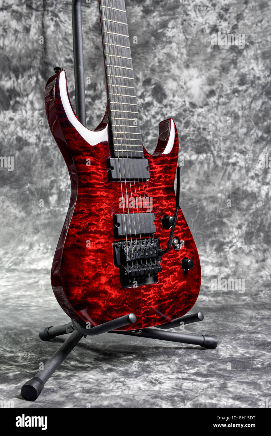 red seven-stringed electric guitar on white-gray background Stock Photo ...
