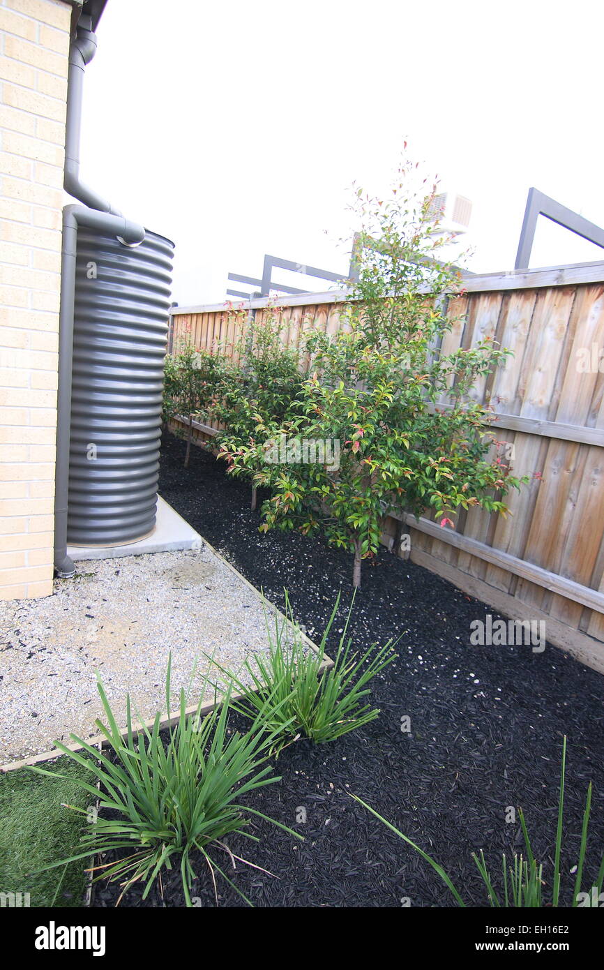 Water tank in the backyard near wooden fence Stock Photo - Alamy