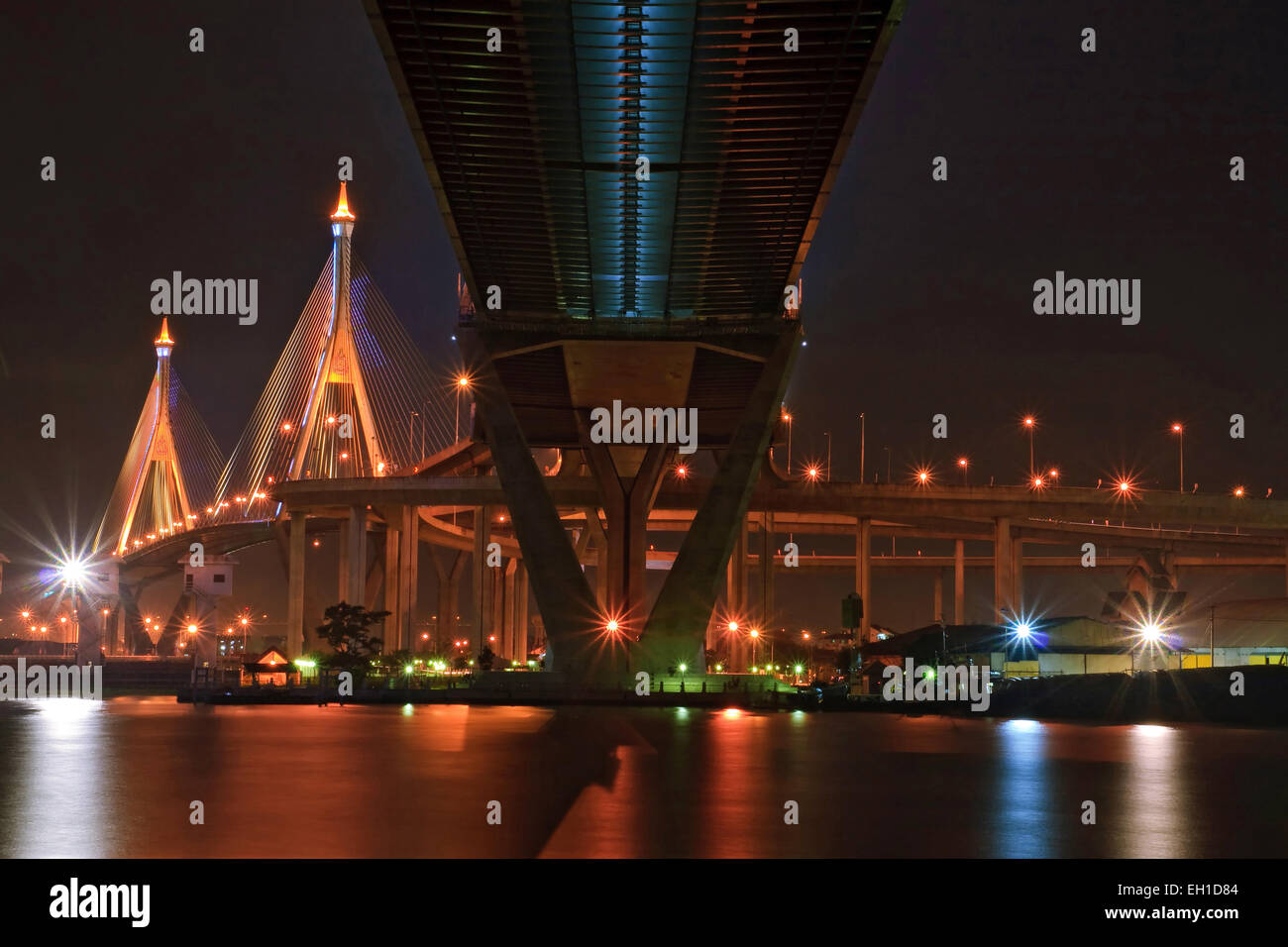 The Industrial Ring Bridge shines at dusk in Thailand with central ...