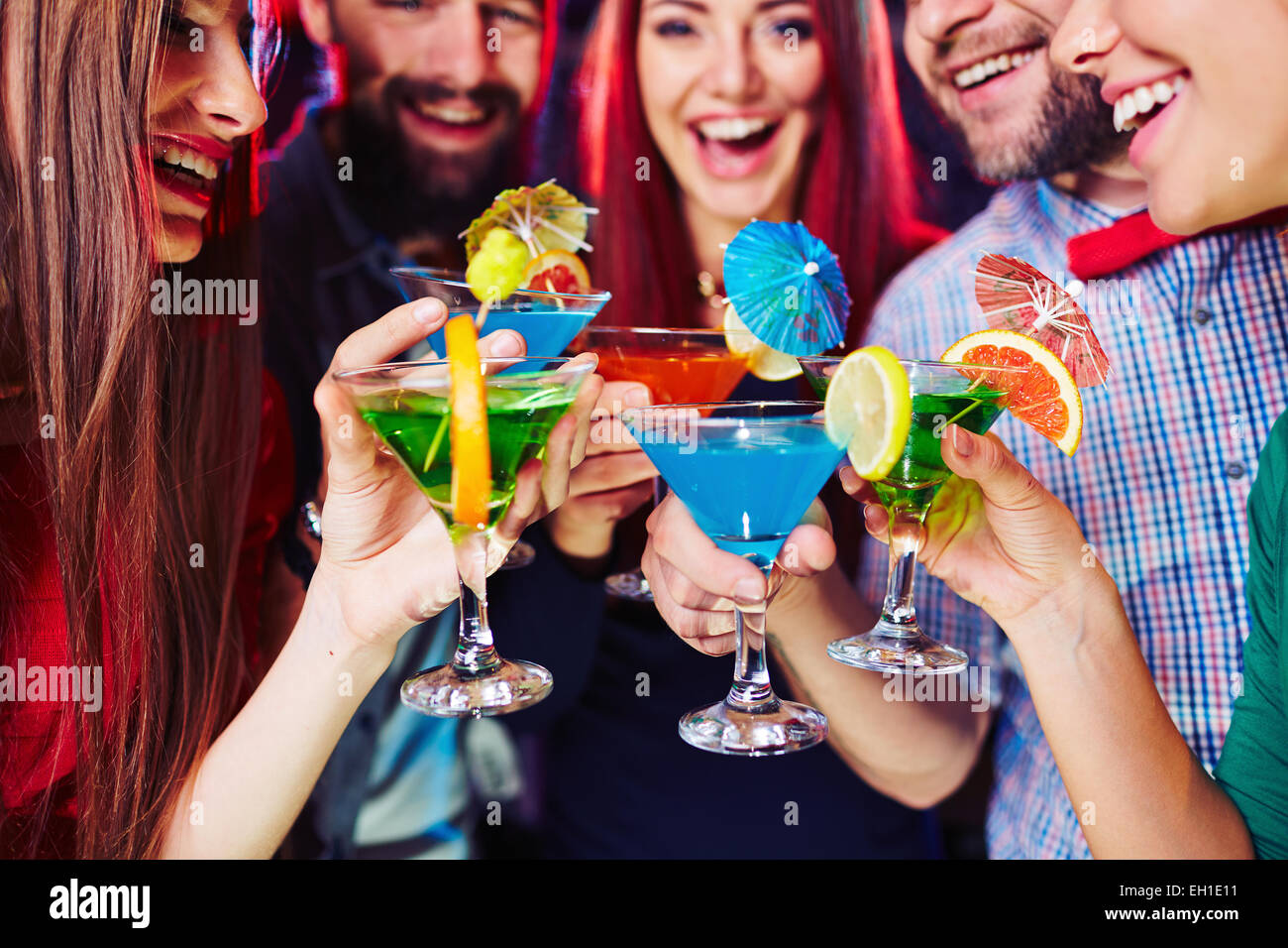 Young people clinking their cocktails Stock Photo - Alamy